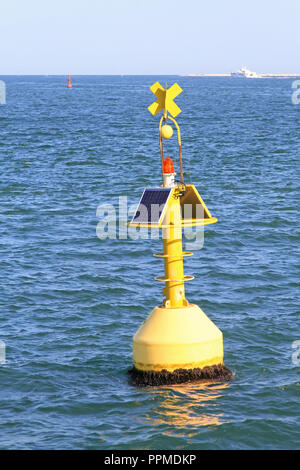 Yellow navigational buoy marker in sea channel Stock Photo - Alamy