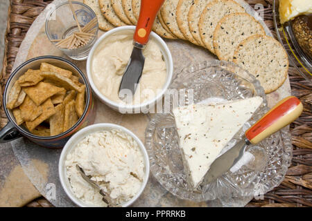 A platter of tasty snacks: cheese, crackers, chips, fruits, and ...