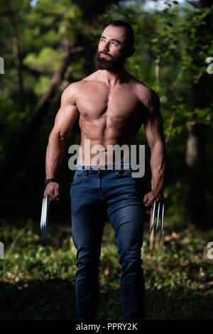 Wolverine With Claws Standing Strong Outdoors and Flexing Muscles ...