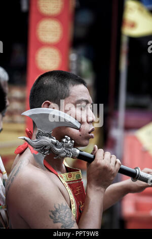 a sword through the mouth at the bizarre Vegetarian Festival Phuket ...