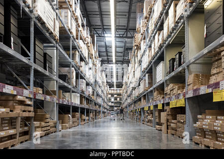 Shoppers looking for flat packed furniture stored on racks in a ...