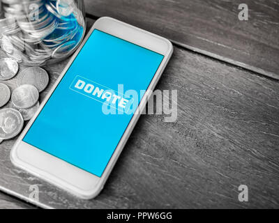 Mobile phone with "donate" on its screen Stock Photo - Alamy