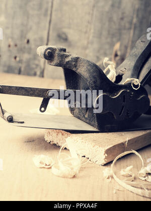 Joinery – old wooden plane, wood polishing tool in a workshop of the ...