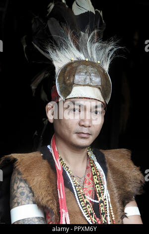 A young Iban man in warrior headhunter regalia, including hornbill ...