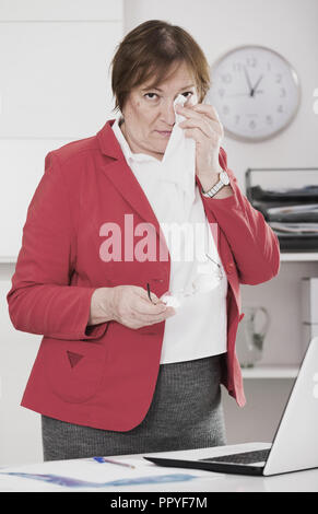 Aged woman worker facing challenge in project in office Stock Photo - Alamy