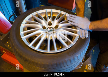 Working process of removing the wheel from the car. Replacing winter ...