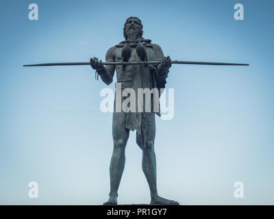 big masculine statue standing in front to the ocean Stock Photo - Alamy