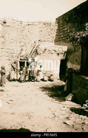 Woman and children in courtyard of house. 1898 Stock Photo - Alamy