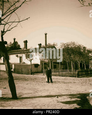 Mikweh. Boy and shy girl in front of building American Colony ...