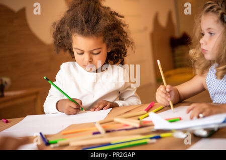adorable multiethnic children drawing with pencils Stock Photo - Alamy