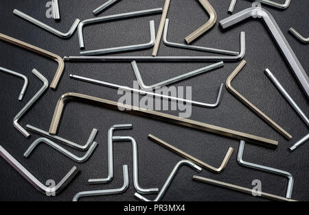 one shiny key lying on top of a bunch of dull keys Stock Photo - Alamy