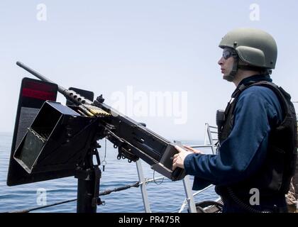 A Marine Corps helicopter equipped with a .50 caliber machine gun ...