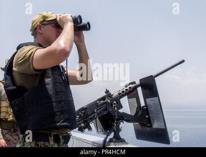 A Marine Corps helicopter equipped with a .50 caliber machine gun ...