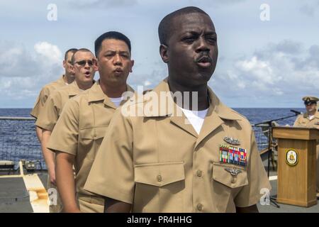 US Navy Newly promoted chief petty officers stand at attention as they ...