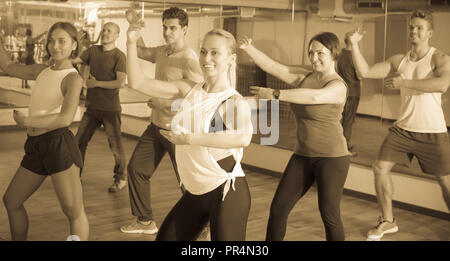 Young happy beginner dancers learning zumba elements together Stock ...