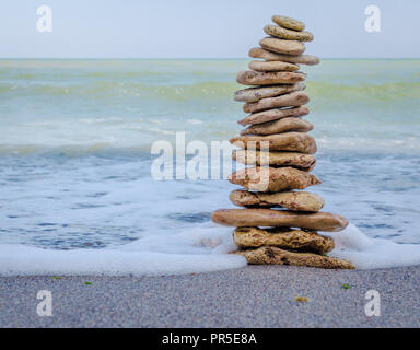 Man made rock formation, tower, on the beach, with waves Stock Photo ...