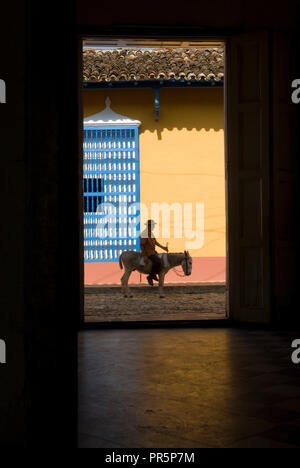 Trinidad local riding his donkey through the centre of town and past a ...