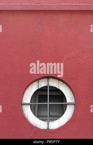 Small round window with security bars cross Stock Photo - Alamy