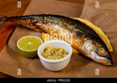 Smoked scomber fish with sauce and lime Stock Photo - Alamy