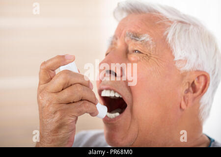 Old man using asthma inhaler Stock Photo - Alamy