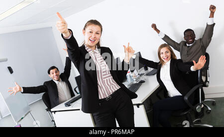 Satisfied multinational business team expressing satisfaction with ...