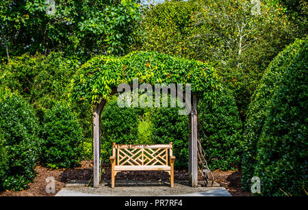 An Empty Wooden Bench in a Landscaped Garden Stock Photo - Alamy