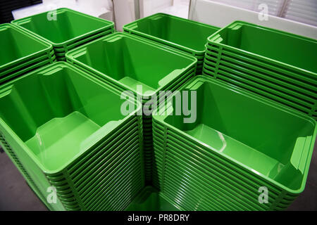 Many folding green boxes containers at store Stock Photo - Alamy