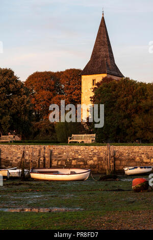 Bosham Bay sunset at low tide with flowers and village in background ...