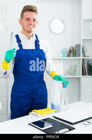 Male handsome professional cleaner doing mopping in the office Stock ...