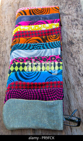 Colorfull leather eye glass cases on wooden background Stock Photo - Alamy