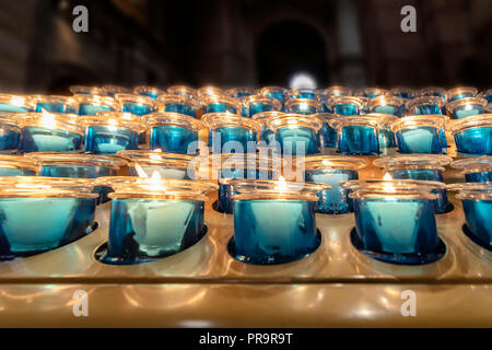Offertory or Prayer Candles burning in remembrance of loved ones in a ...