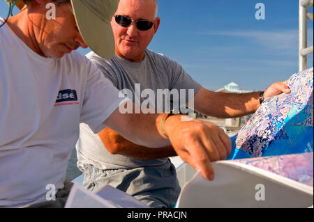 EPA workers checking maps during the BP Oil Spill clean up in 2010 ...