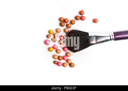 Pink and purple makeup balls with brush on white background isolated ...