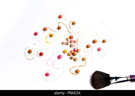 Pink and purple makeup balls with brush on white background isolated ...