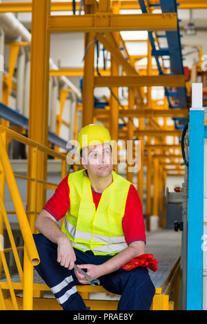 Sitting, professional man worker is maintenance station with tires ...