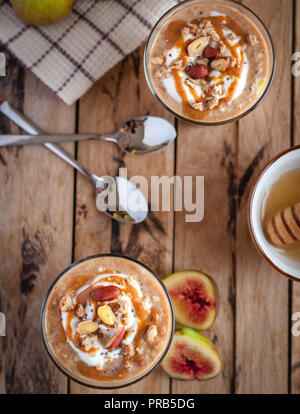 Top view of fresh sweet figs arranged on wooden chopping board on dark ...