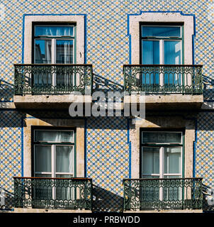 Lisbon windows with typical portuguese tiles on the wall. Selective ...