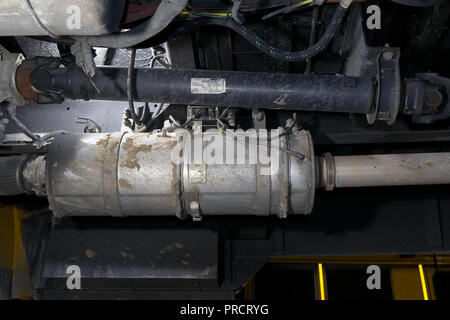 A diesel particulate filter in the exhaust system in a car on a lift in ...