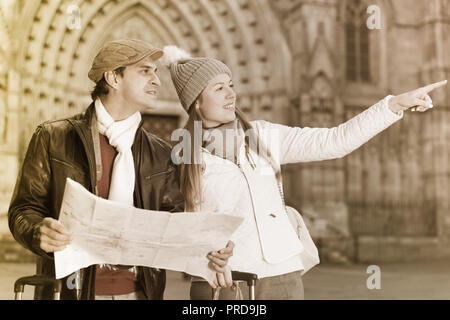 Portrait of adult tourists standing with map at street in hats Stock ...