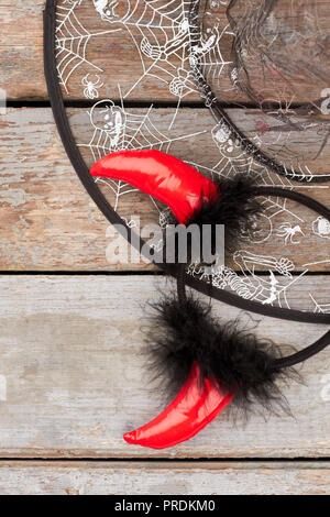 Devil hair band on wooden background Stock Photo - Alamy