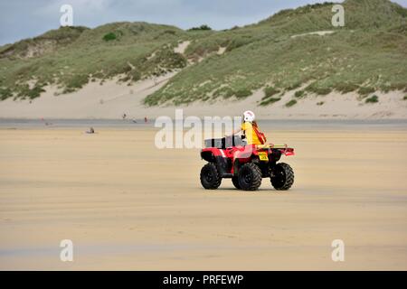ATV quad bike being ridden by an RNLI lifeguard,Perranporth beach ...