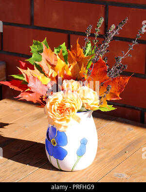 Autumn flower composition with roses and maple leaves Stock Photo - Alamy