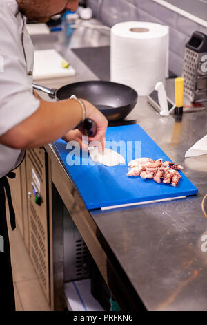 Male cook slicing seafood in restaurant kitchen.Delicious food Stock ...