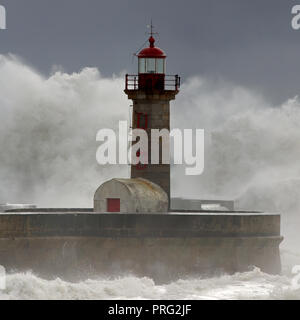 Huge Atlantic waves over Douro river old pier lighthouse in a stormy ...