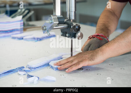 tailor with electric knife cut outs parts for sewing. industrial ...