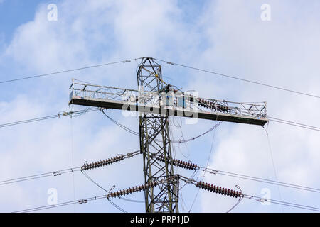 A temporary work platform attached to an electricity pylon for workers ...