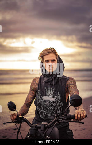 Handsome young biker looking at camera Stock Photo - Alamy