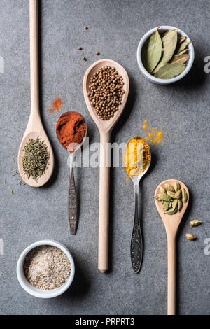 Spoons with aromatic spices on grey background, closeup Stock Photo - Alamy