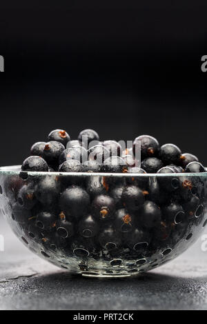 Photo of black currant in glass transparent cup Stock Photo - Alamy