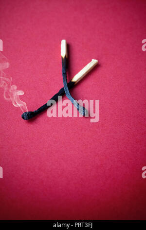 Two Burnt Matches Cross Stock Photo - Alamy
